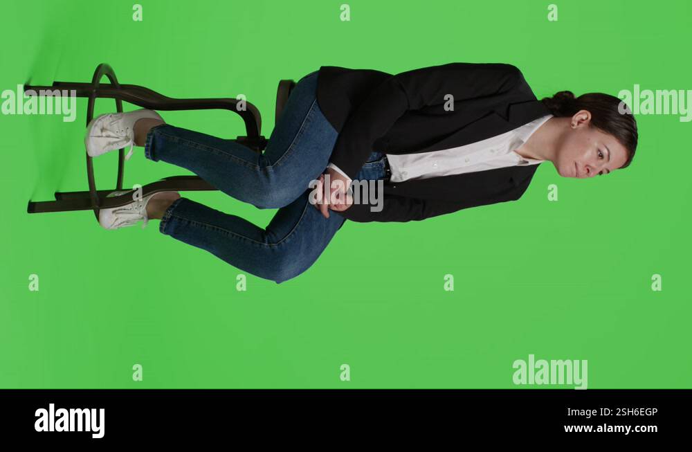 Vertical video: Side view of company employee sitting on chair and ...