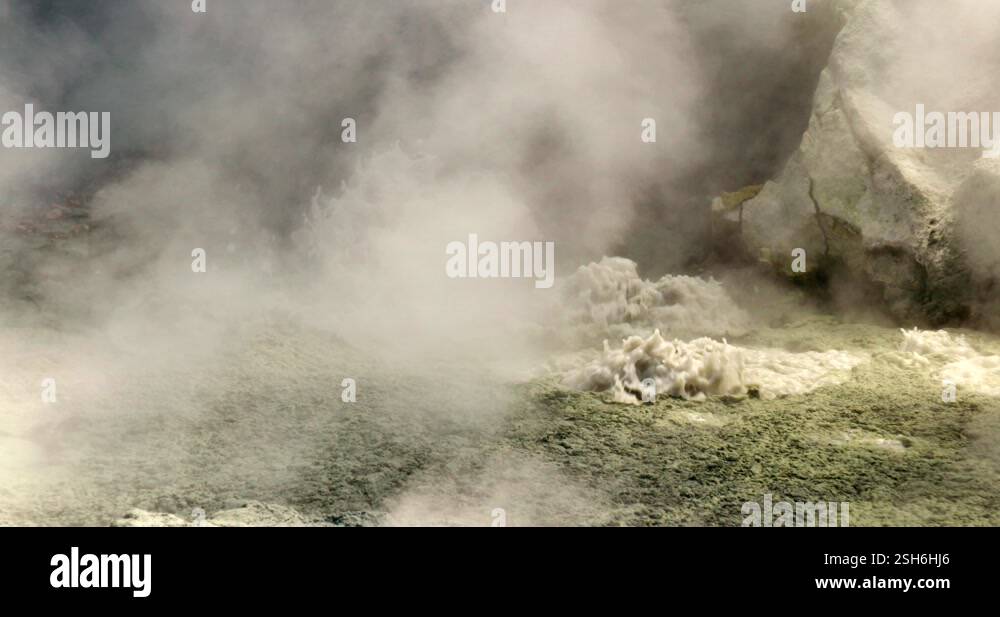 Toxic geothermal sulfur mud pool boiling water and emitting steam Stock ...