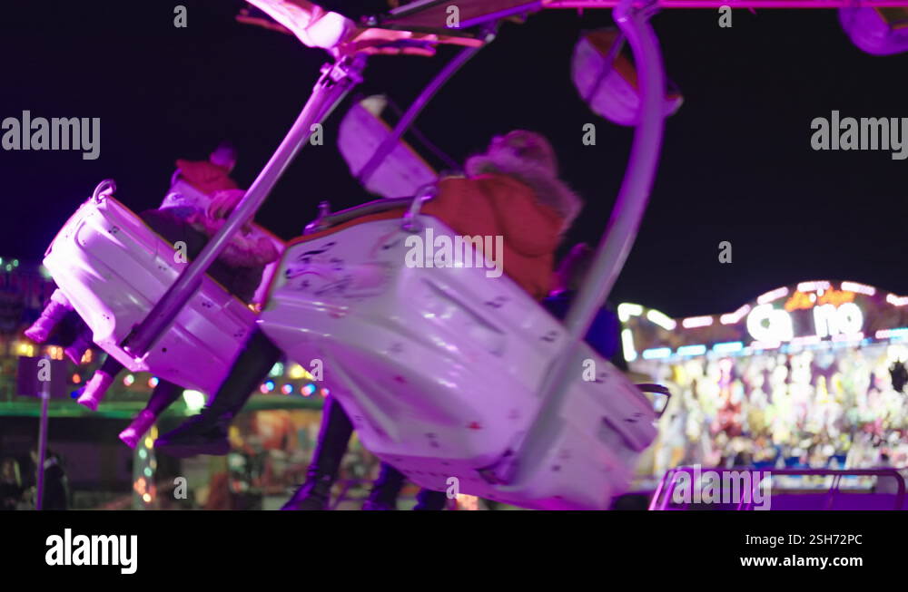 Ferris wheel ride empty seats in amusement park at night in slow motion ...