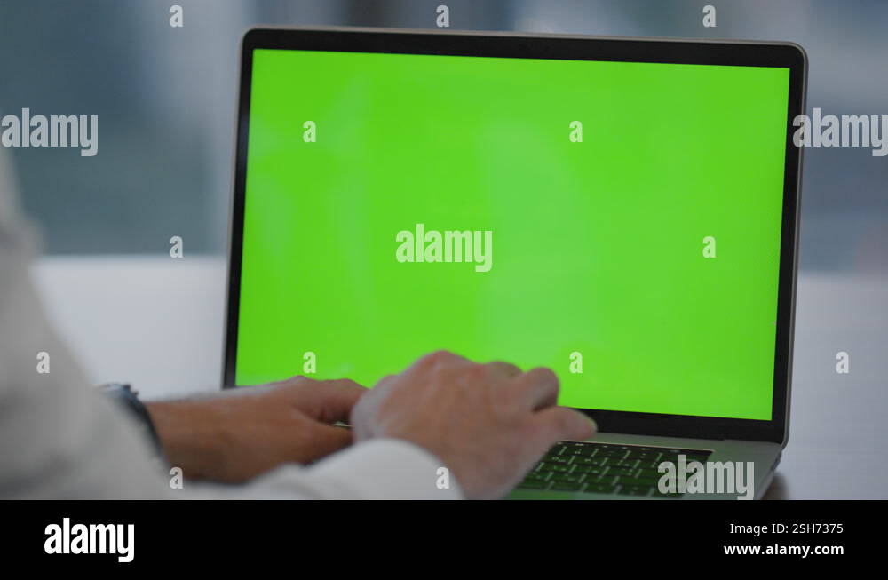 Hands writing green screen laptop in office closeup. Businessman typing ...