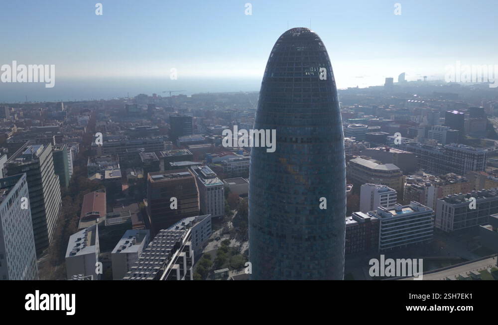 flying counter clockwise around iconic Torre Glories skyscraper in Barcelona Stock Video Footage ...