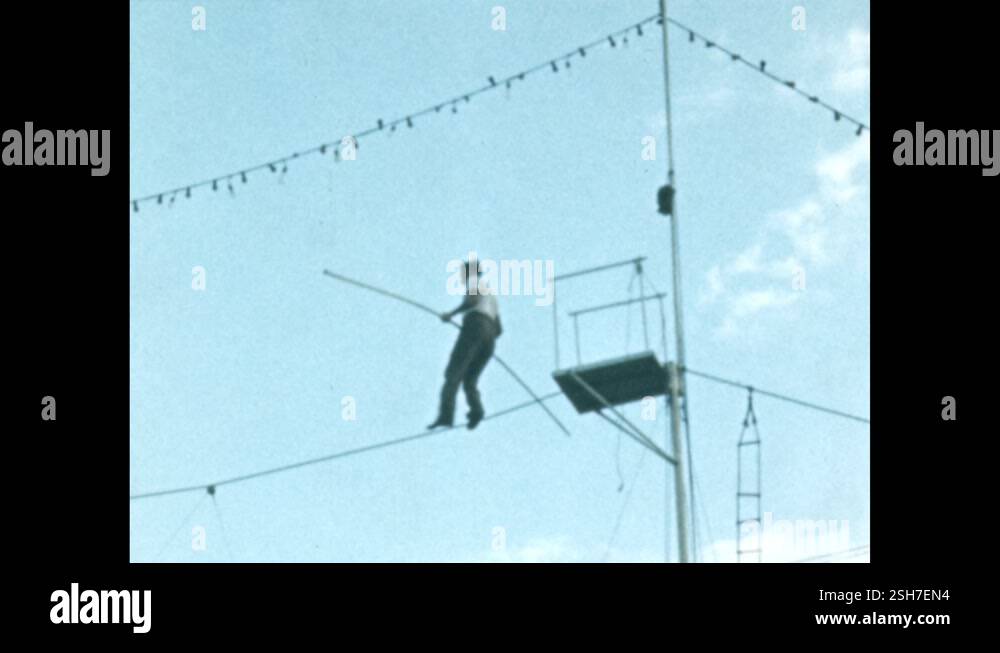 1960s: Elephant doing tricks at the circus. Man walking a tightrope ...