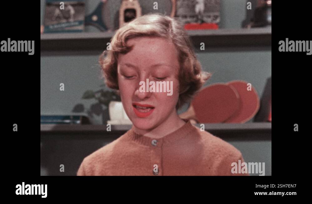 1950s: Kids gathered around a model talking. Girl talking. Features of ...