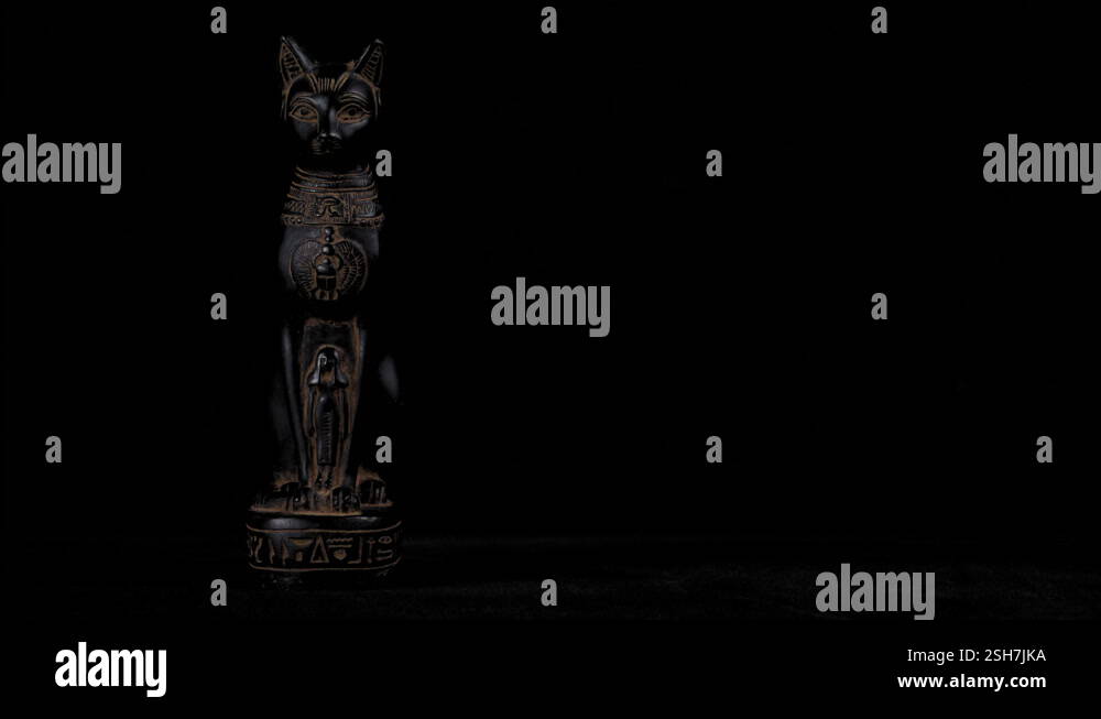 Dolly of a small replica Egyptian Statue of Bastet facing forward ...