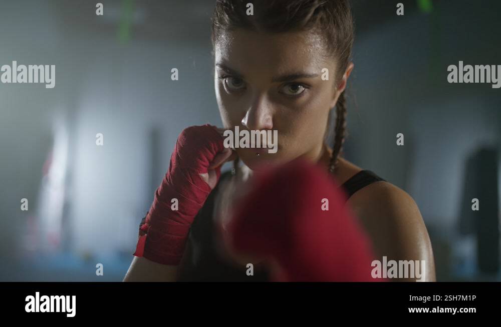 Woman power, young female fighter stands in a combat stance and looks ...