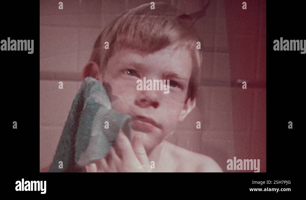 1970s: Boy scrubbing his face with a wash cloth. Boy in the shower. Father Stock Video Footage ...