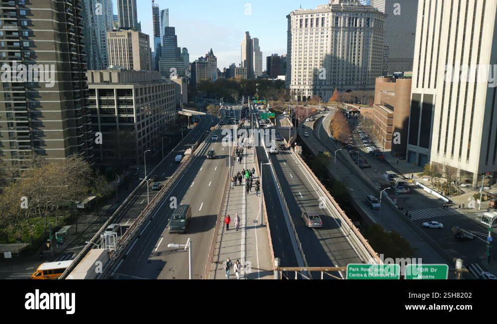Busy pavement in middle of multilane road surrounded by high rise ...