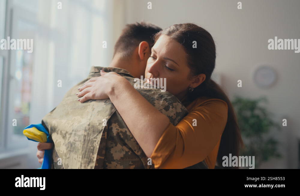 Sad wife hugging her husband with Ukrainian army military patch, going to war Stock Video ...