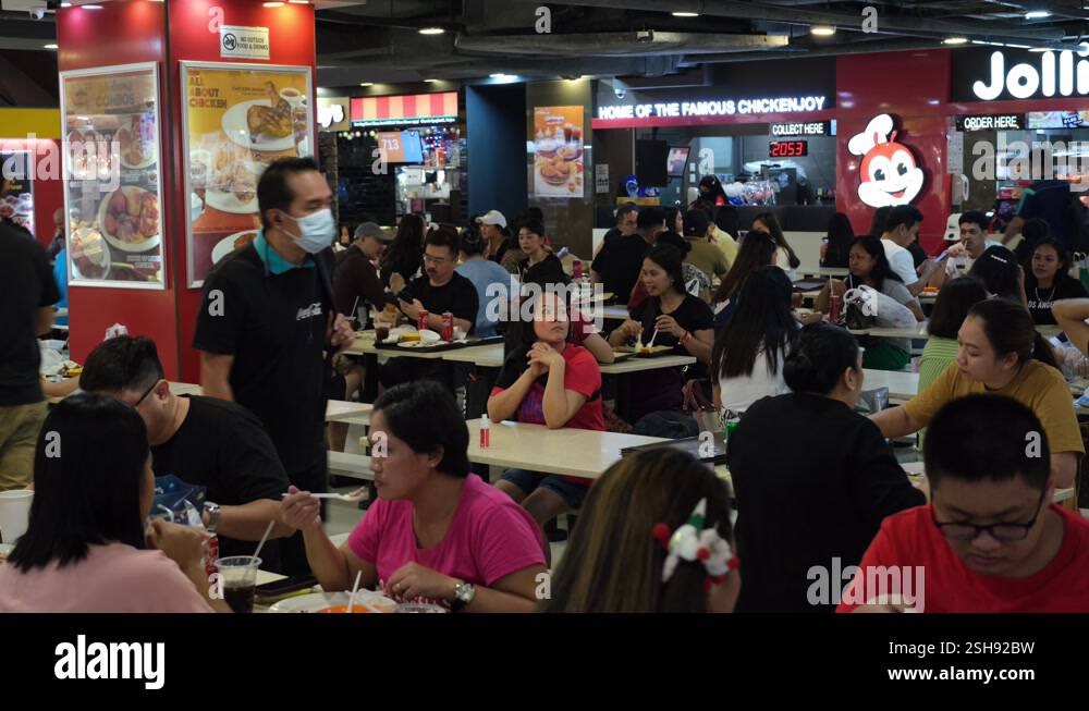 People eating at the food places inside the Mall of Lucky Plaza in ...