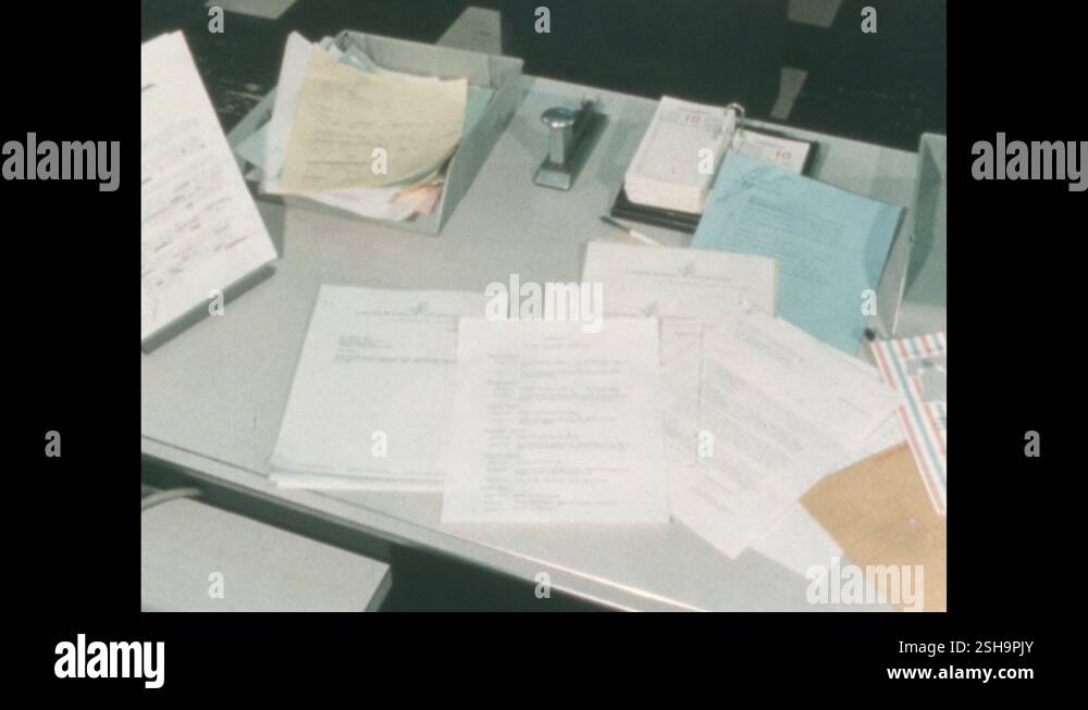 1960s: Woman typing on typewriter. Shots of paperwork piling up on desk ...