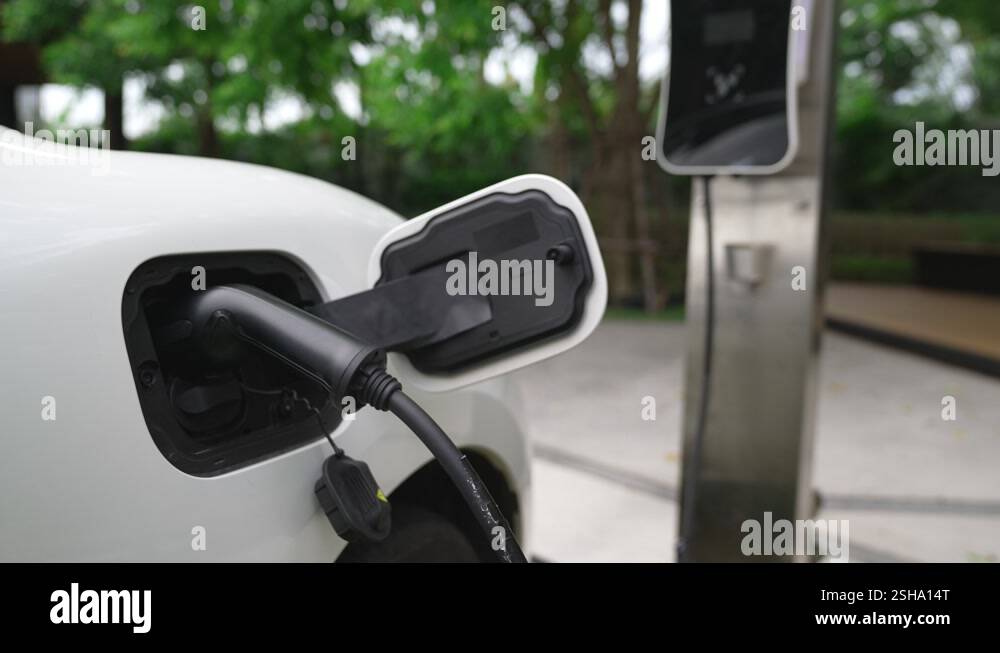 Progressive man install cable plug to his EV car from home charging ...