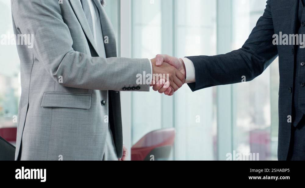 Businessman in a suit shaking hands with a man colleague, a handshake ...