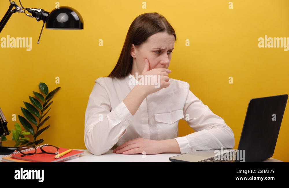 Woman sit work at office desk with laptop biting nails fingers oops ...