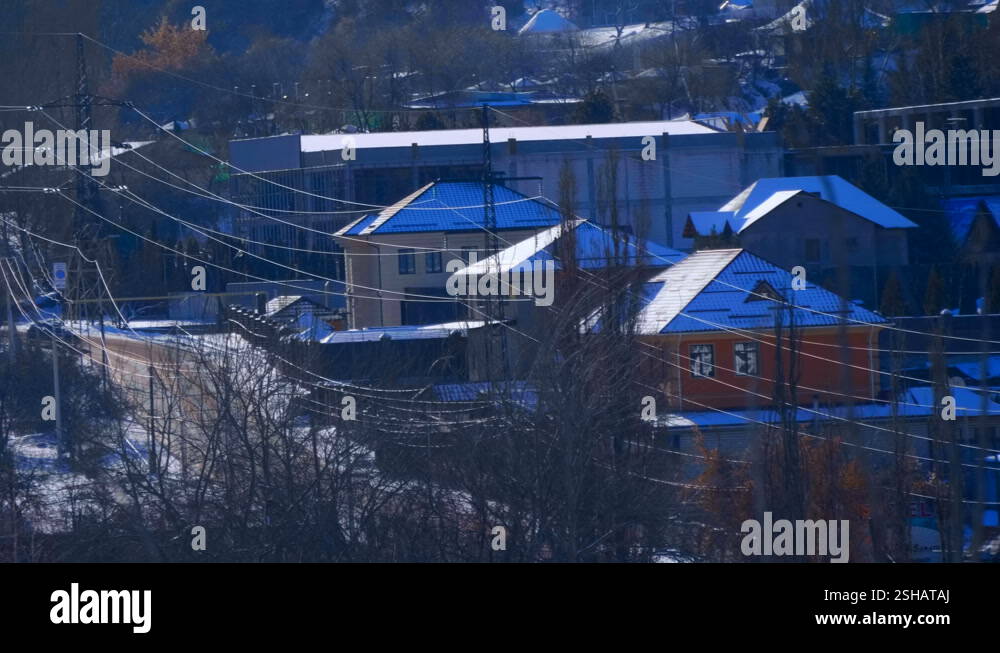Power lines passes through a settlement and deliver electricity to ...