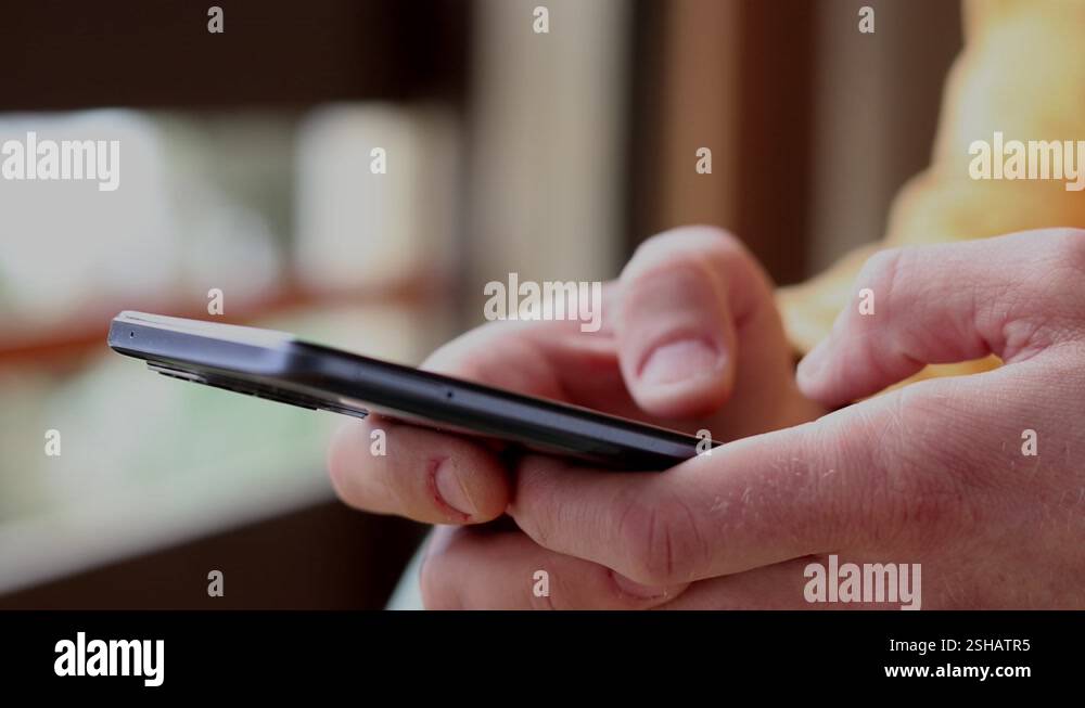 a man uses a cell phone to record and send a close-up message. Hold a ...