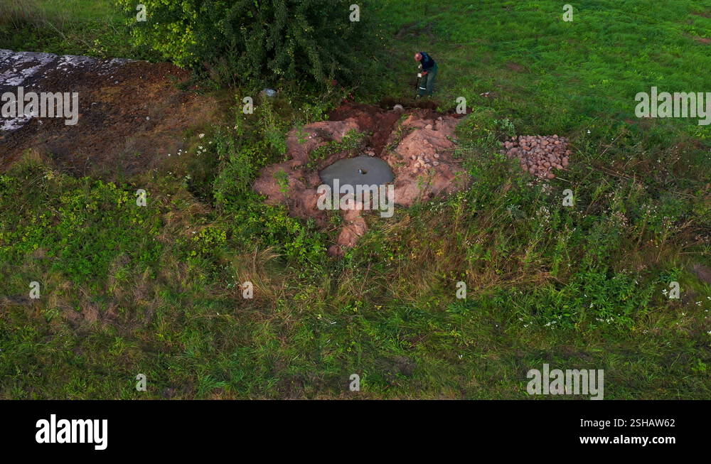 Man digging ground with shovel in rural area, aerial view Stock Video ...