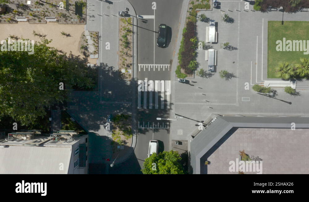 Static aerial perspective of two vehicles driving on left hand side ...