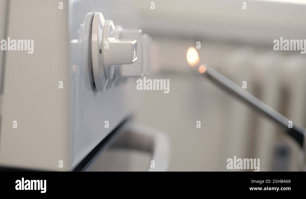 A Man Lighting Up Fire at Gas Cooker with a Lighter. Close-up shooting ...