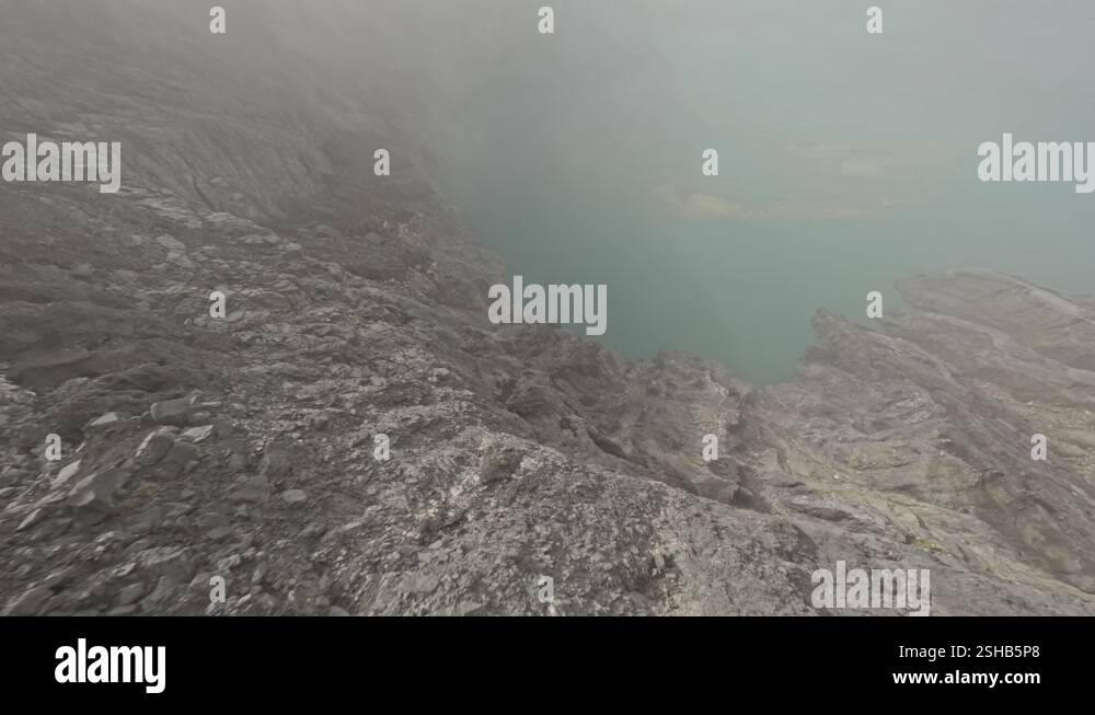 Extreme dive to cloudy volcano crater island mountain crack stone sharp ...