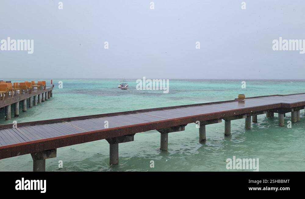 Rainy Season in Maldives, Falling Rain on Dock of Luxury Island Resort ...