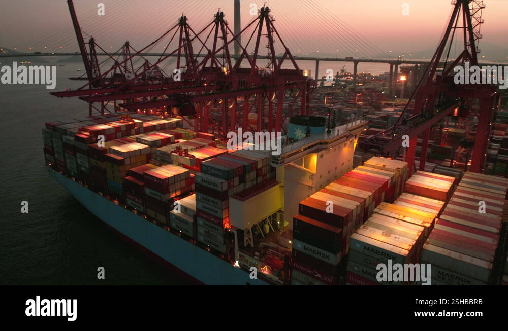 Giant Maersk line vessel moored in Hong Kong while one of the red ...