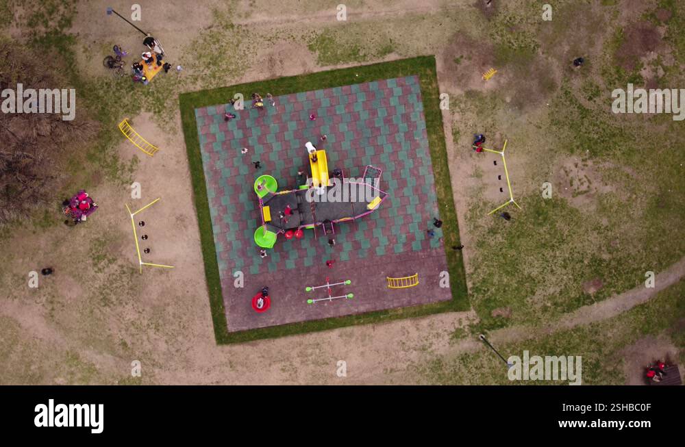 A dynamic pivoting aerial footage of kids playing around the children's ...