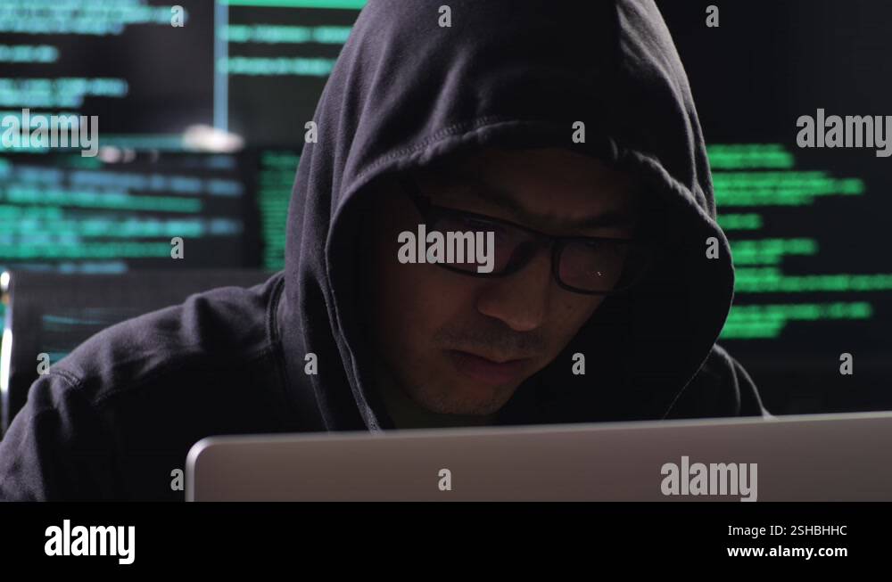 Close Up Of Asian Male Hacker In A Hood Having A Headache While Works ...