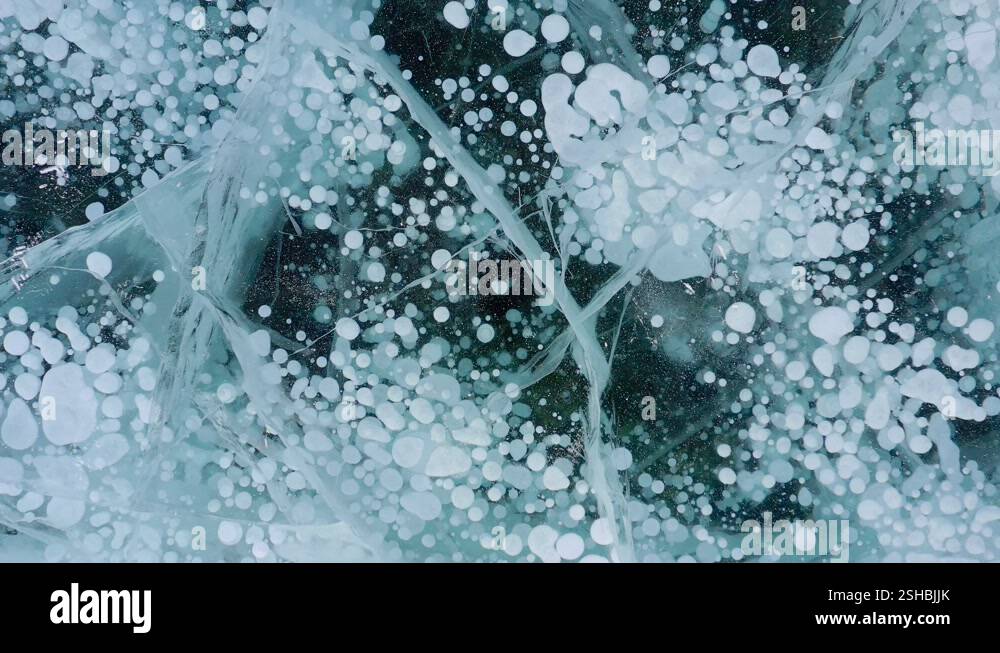 Frozen methane bubbles and cracks in the ice on Lake Baikal Siberia ...