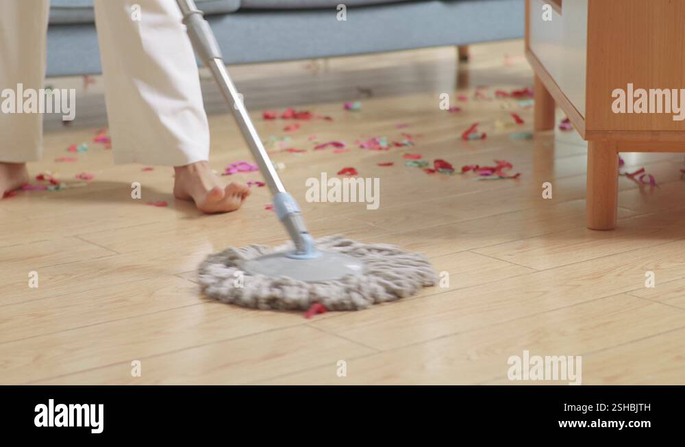 Close Up Of A Mop Being Used By Woman To Clean The Floor After ...