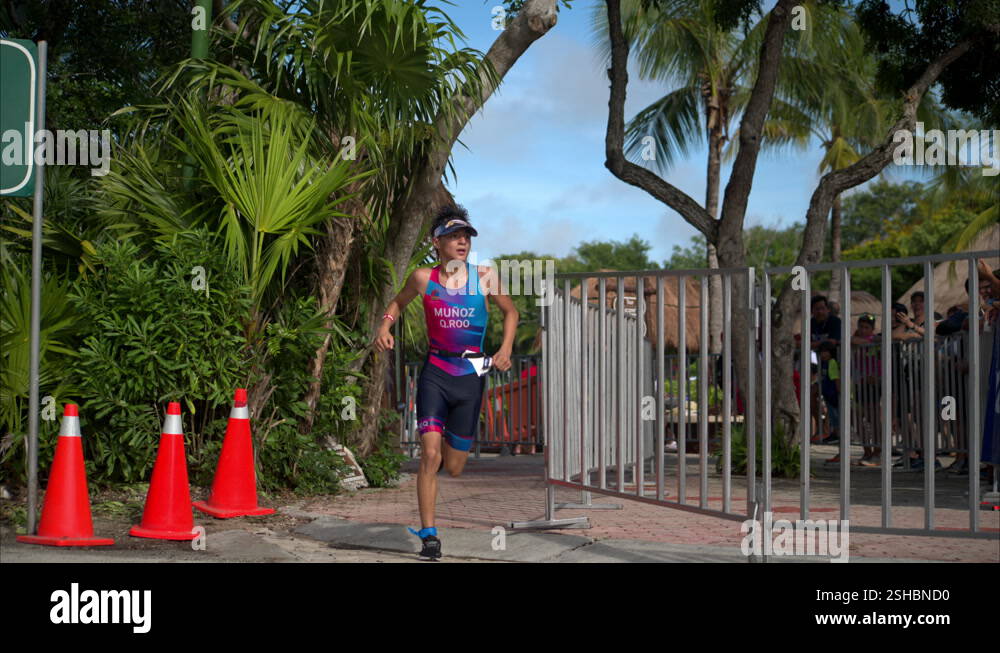 Slow motion of a teenage athlete running entering the final meters of a ...