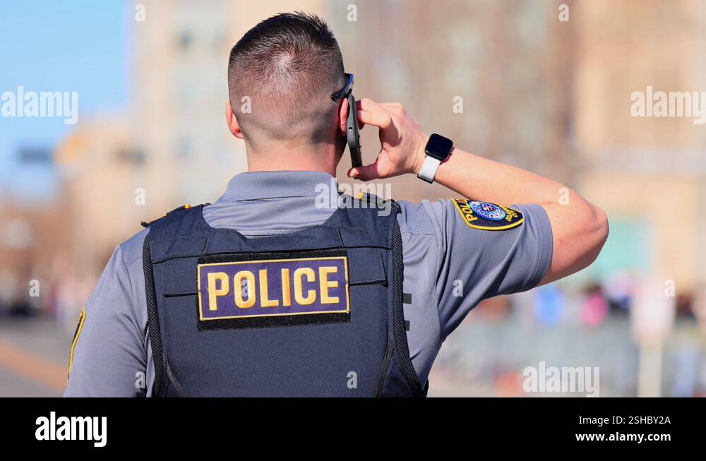 A close-up shot of an officer engaged in a phone conversation Stock ...