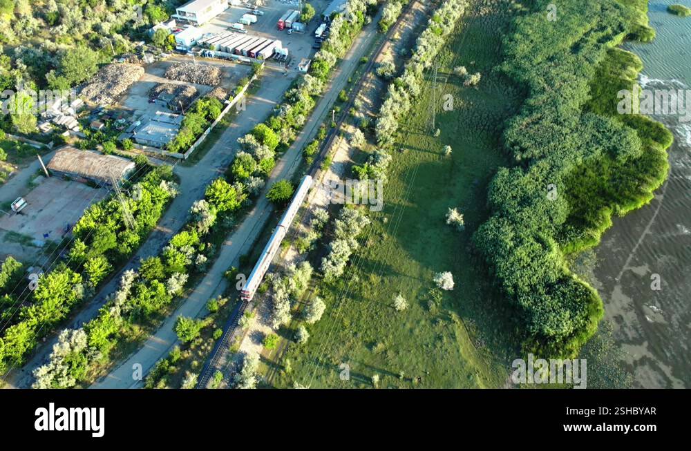 Aerial Tracking Shot Of Moving Train Next To A Lake In Daytime Stock ...