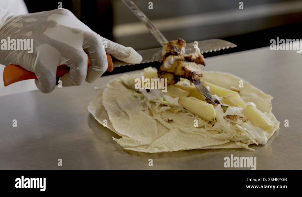 Chef Removing Grilled Chicken From Skewer With Knife Over Sandwich ...