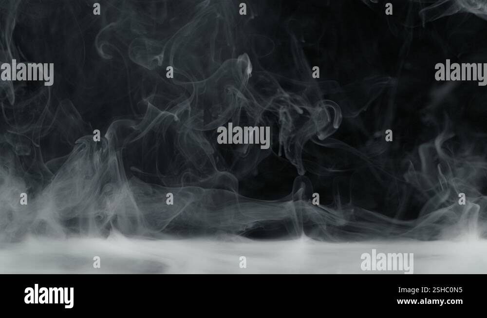 Super Slow Motion Shot of Abstract Flowing Smoke Isolated on Black at ...