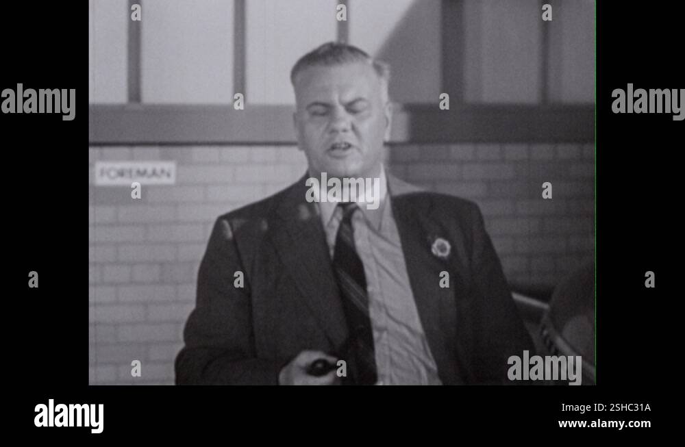 1940s: Man holds smoking pipe and speaks. Worker speaks to foreman and ...