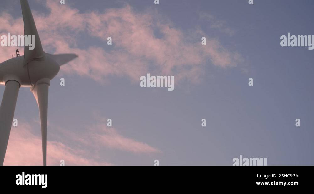 Wind turbine windmill turning in a blue sky with clouds Stock Video ...