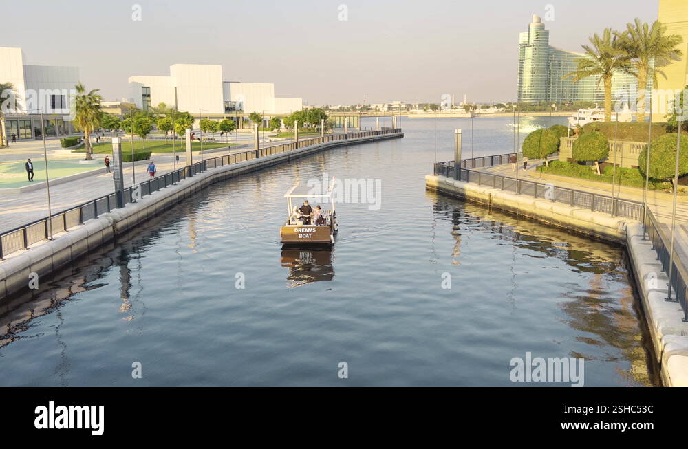 Small boat sailing through a canal into the Dubai creek river, near the ...