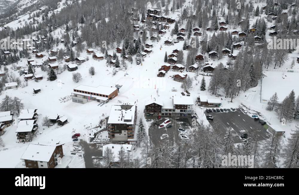 The winter ski resort Bellwald with the chairlift and a large parking ...