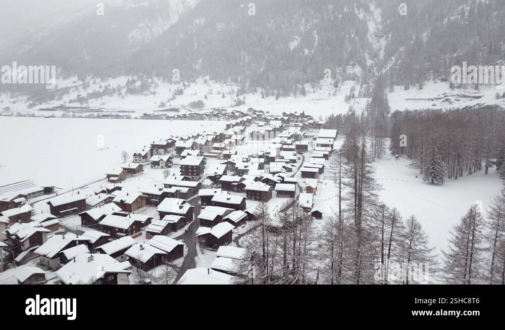 A village in a snowstorm. Winter in Oberwald, the Swiss mountain ...