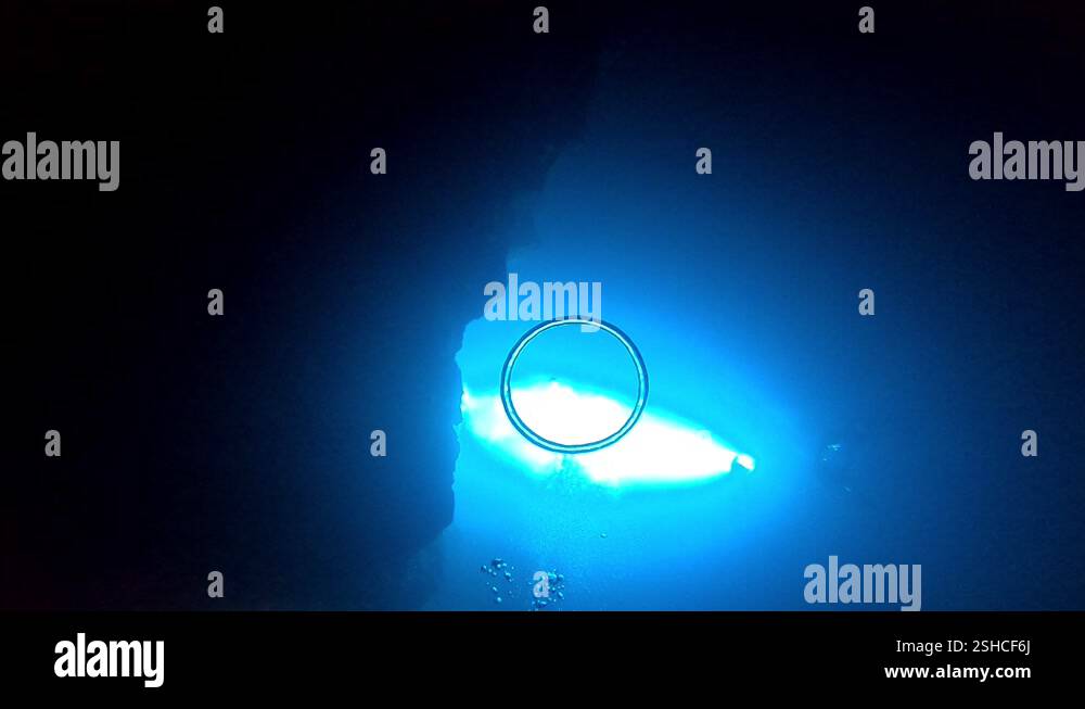 A bubble ring ascending to the surface in a clear underwater cave Stock ...