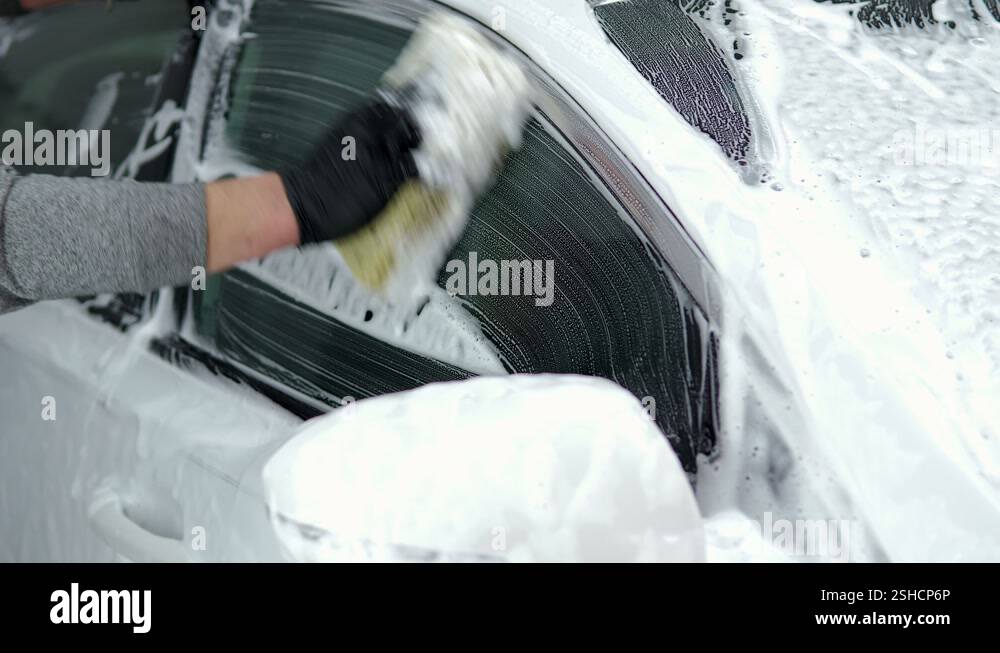 Worker in garage automobile service. Close-up of a man's hand washing ...