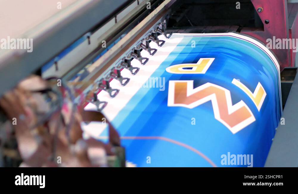 A large-format inkjet printer prints an advertising banner. The print ...