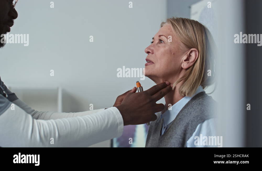 Doctor Checking Reaction of Eye Pupils of Mature Patient During ...
