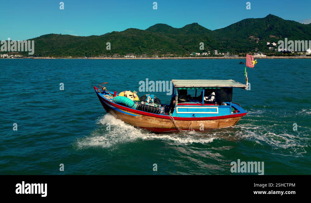 Fishermen come out of the boat bay. On a sunny morning, a fishing boat ...