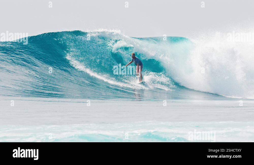 Surfer rides the big wave in the Maldives, Sultans surf spot during big ...