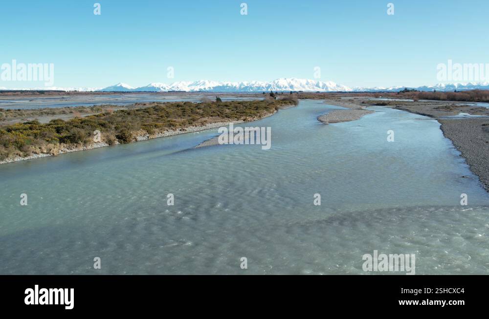 Flying low across beautiful Rakaia River (New Zealand) to show ...