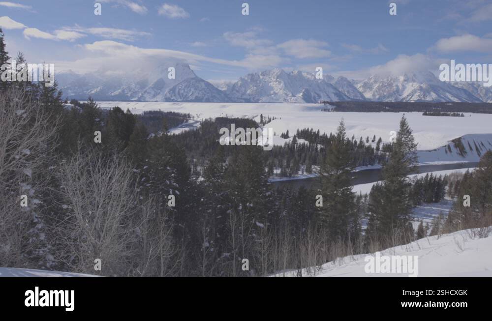 Handheld panning shot of the Teton range with the Snake River in the ...