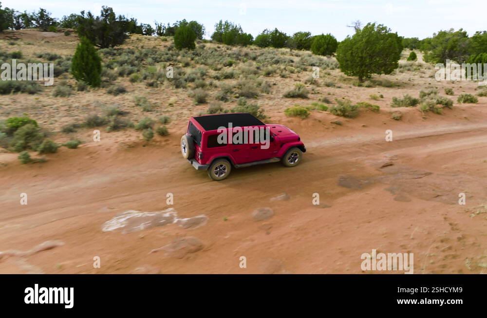 Red Jeep Wrangler Driving On Off-Road Trail To White Pocket In Utah ...