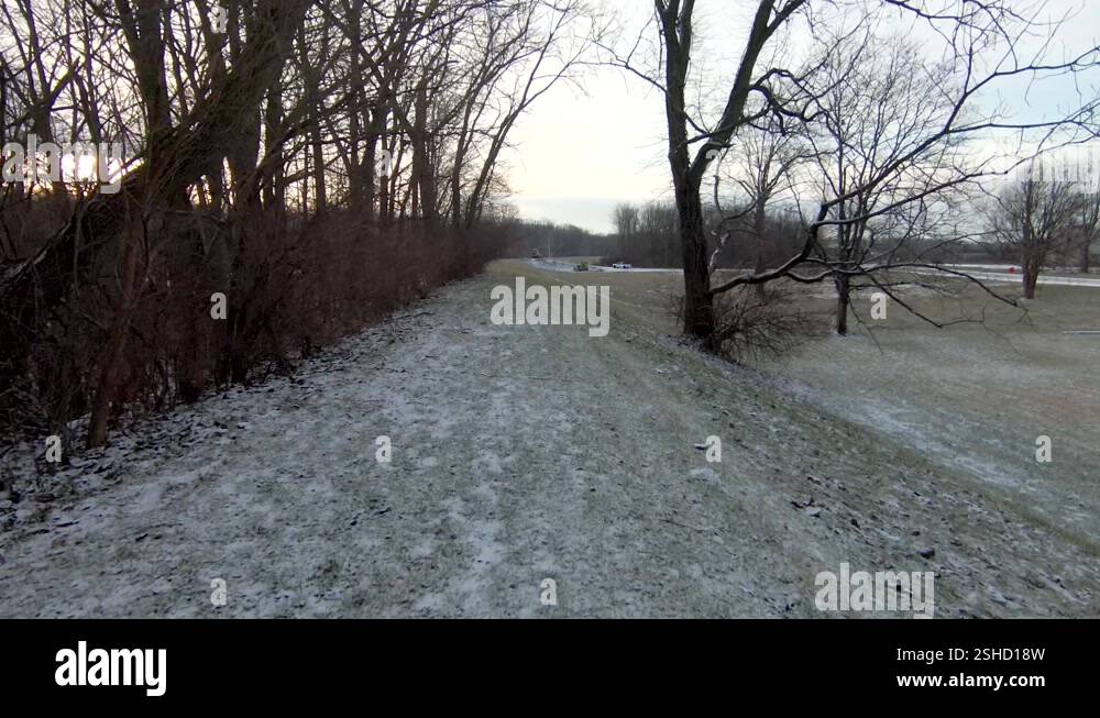 Aerial flying low over lawn covered with little snow. Winter concept ...