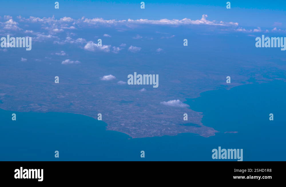 Flying above coastal terrain with clouds on the horizon Stock Video ...